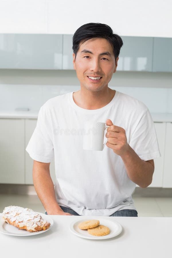 Smiling Young Man Drinking Coffee in Kitchen Stock Image - Image of ...