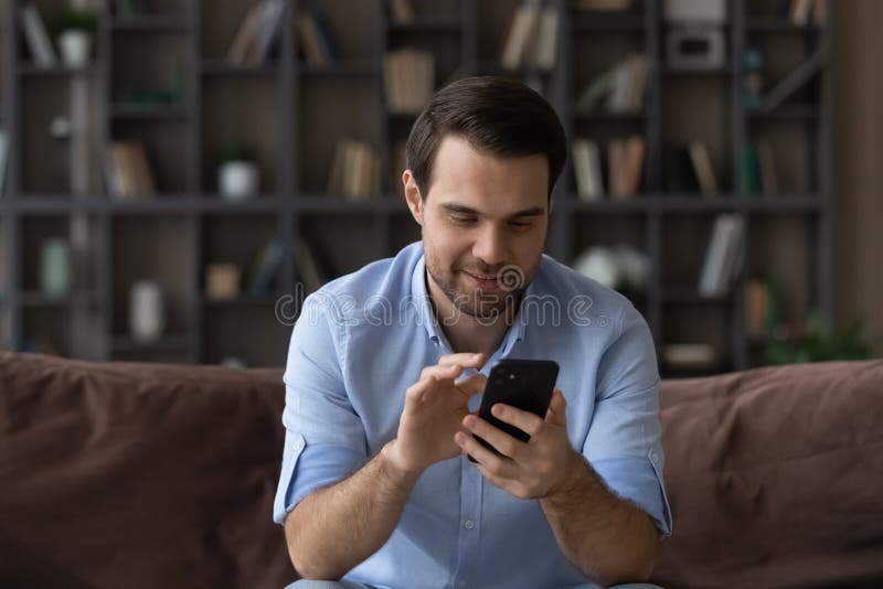 Smiling Young Man Enjoying Using Mobile Application. Stock Image ...