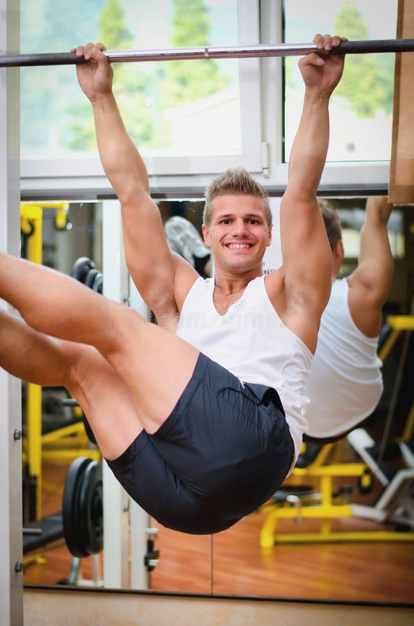Young Man in Gym Hanging Upside-down To Exercise Abs Stock Image ...