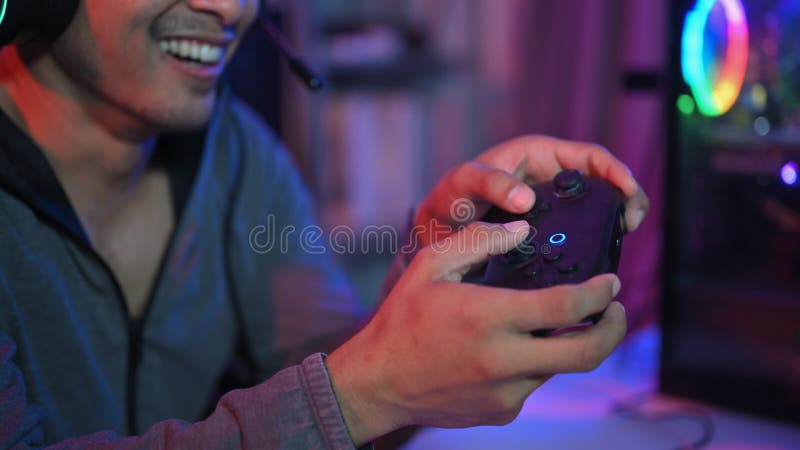 Smiling Young Man Holding Controller Playing Video Game in Gaming Room ...