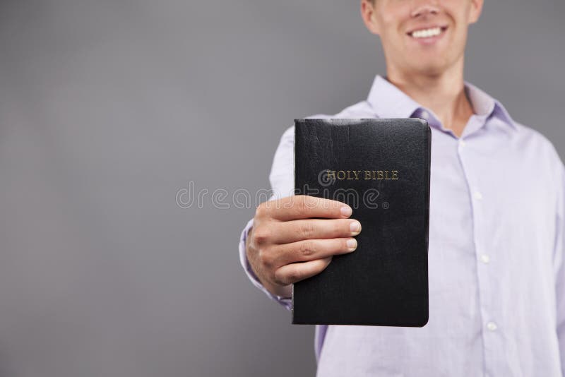 Smiling Young Man Holds Bible Stock Image - Image of happy, faith: 26131711