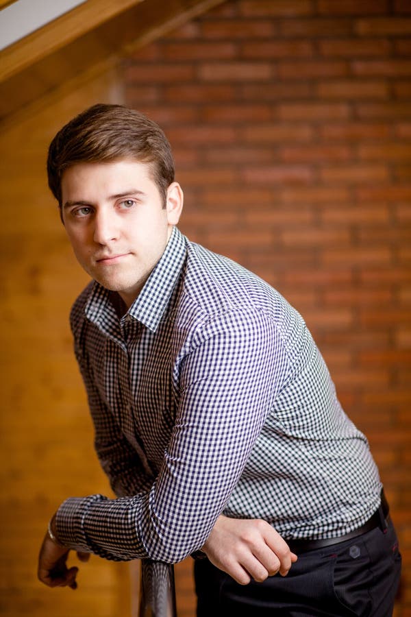 Smiling Young Man Leaning Against Brick Wall Stock Image - Image of ...