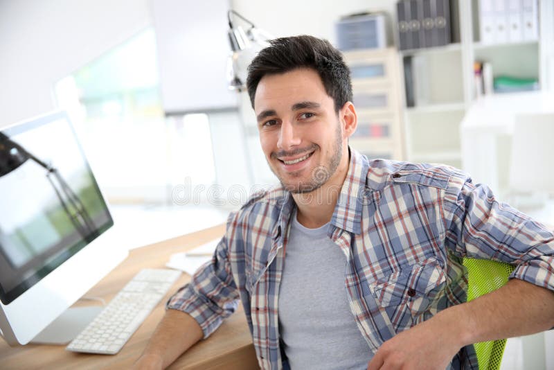 Smiling Young Man at Office Stock Image - Image of caucasian, worker ...