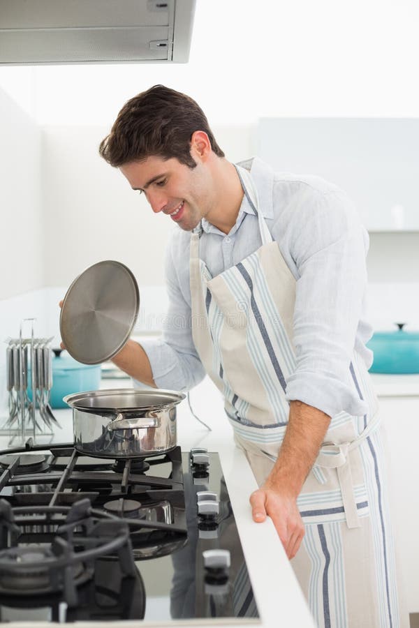 Smiling Young Man Preparing Food in Kitchen Stock Photo - Image of view ...