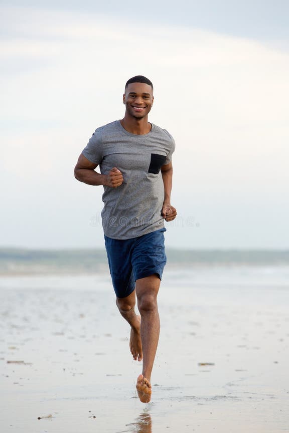 Smiling Young Man Running Barefoot Stock Photo - Image of leisure ...
