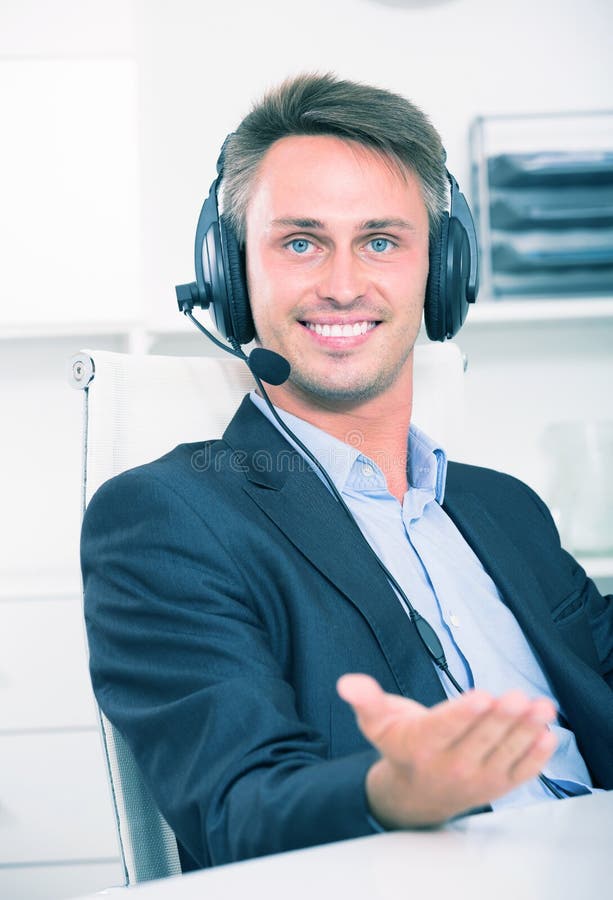 Smiling Young Man Talking on Headset at Office Stock Image - Image of ...