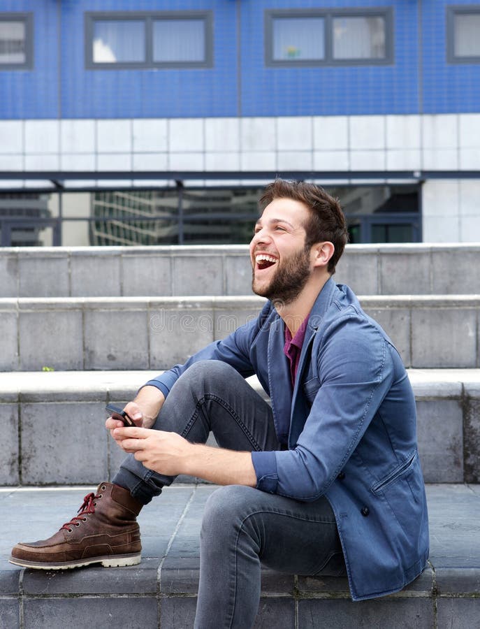 Smiling Young Man Text Messaging on Cellphone Stock Photo - Image of ...