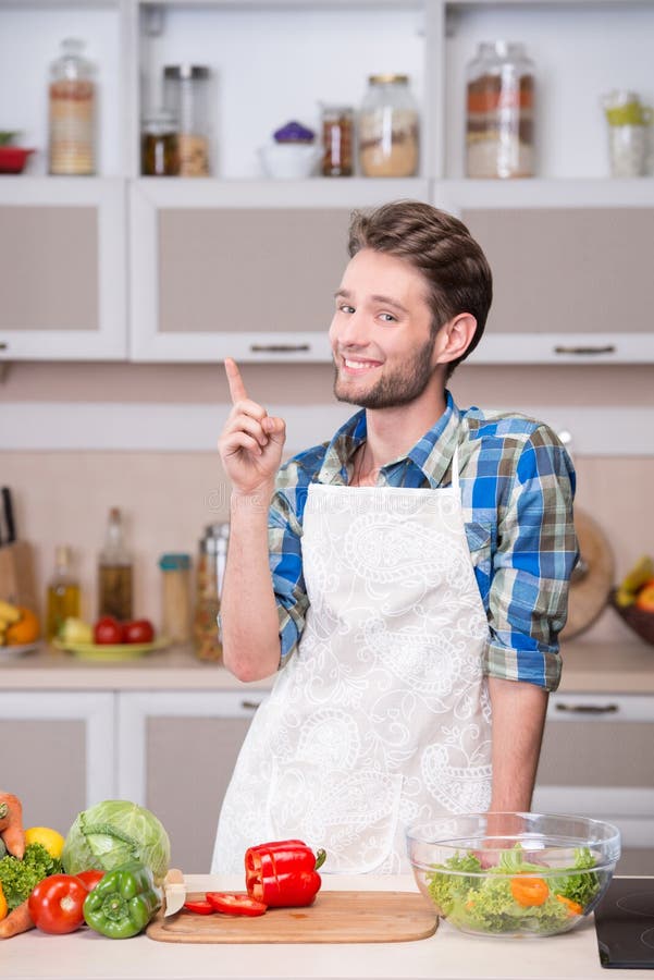 Smiling Young Man Trying To Cook Dinner in Kitchen Stock Photo - Image ...