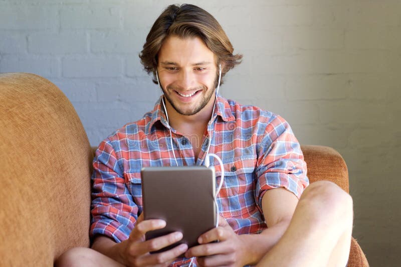 Smiling Young Man Watching Video on Tablet with Headphones Stock Image ...