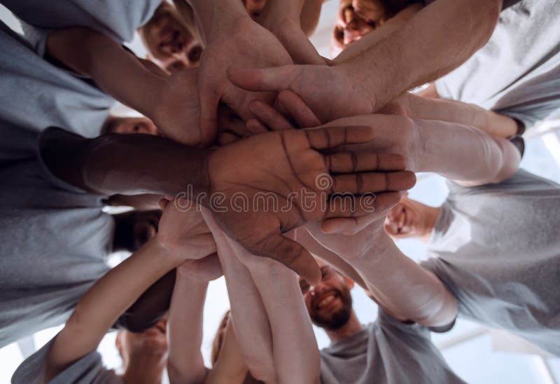 Smiling Young People Making a Tall Tower Out of Their Hands Stock Image ...