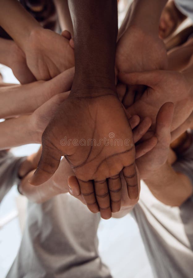 Smiling Young People Making a Tall Tower Out of Their Hands Stock Photo ...