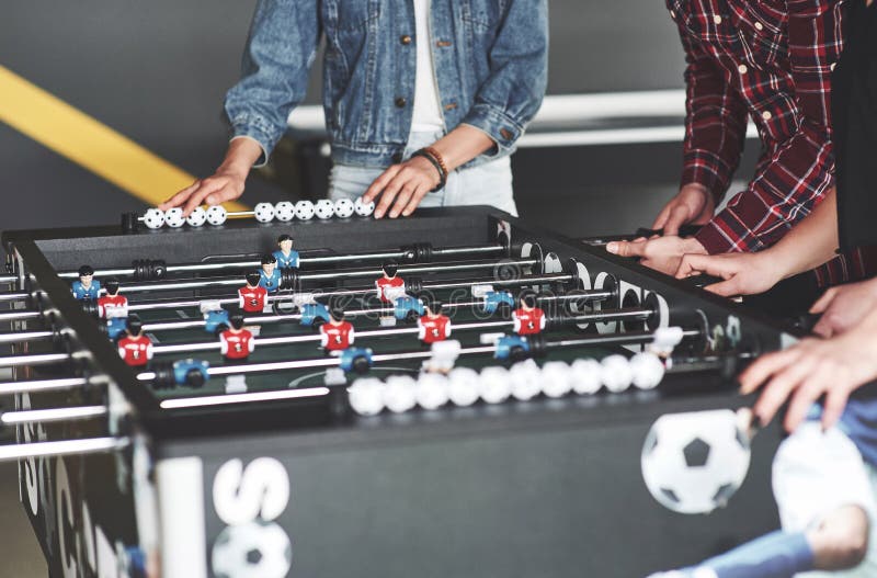 Smiling Young People Playing Table Football while on Vacation Stock ...