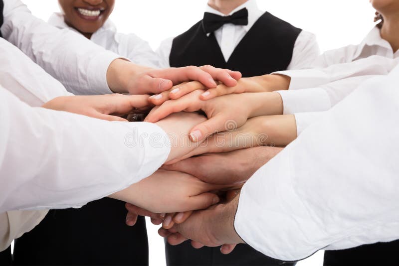 Smiling Young Restaurant Staff Stacking Hands Stock Photo - Image of ...