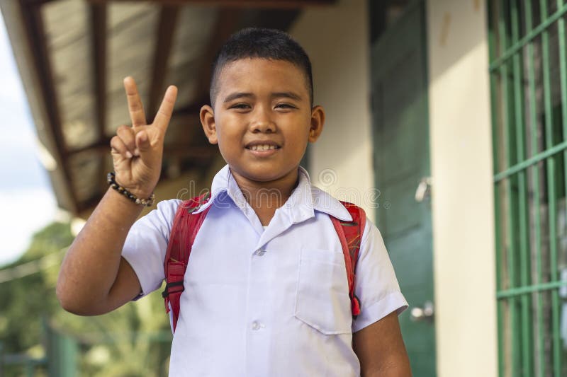 Smiling Young Student in Uniform with Backpack Outside His Classroom ...