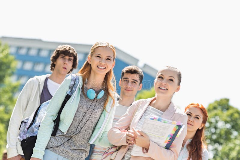 Smiling Young Students Standing Together at College Campus Stock Image ...