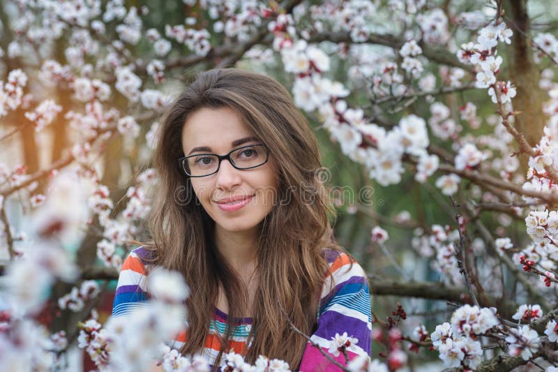 Smiling Young Woman in the Blossoming Spring Garden Stock Photo - Image ...
