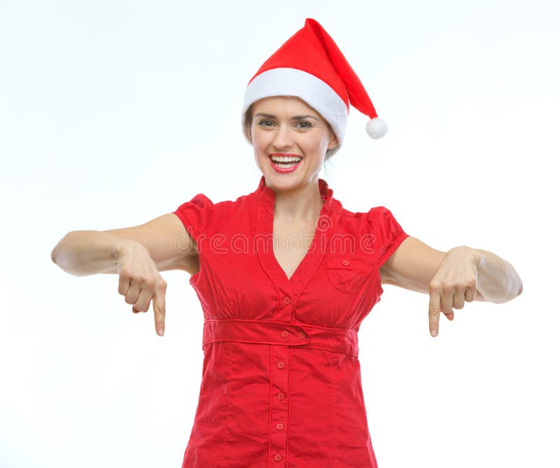 Smiling Young Woman in Christmas Hat Pointing Down Stock Photo - Image ...