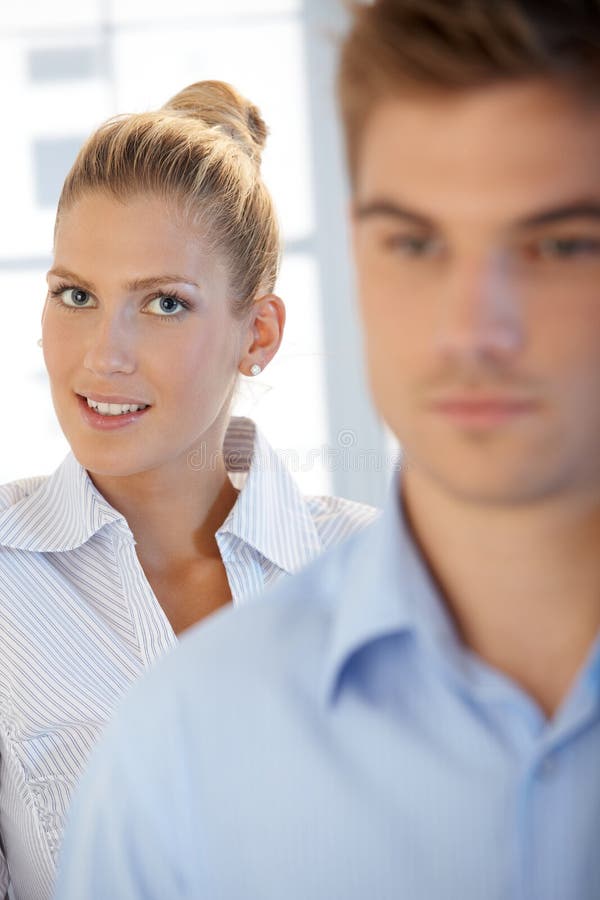 Smiling Young Woman in Focus Stock Photo - Image of coworkers ...