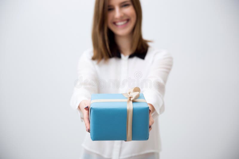 Smiling Young Woman Giving Gift Stock Image - Image of gray, giving ...