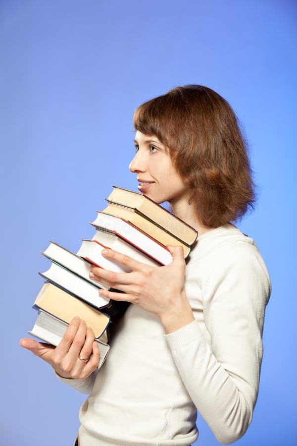 The Smiling Young Woman Holding a Stack of Books Stock Photo - Image of ... The Smiling Young Woman Holding a Stack of Books Stock Photo - Image of ...