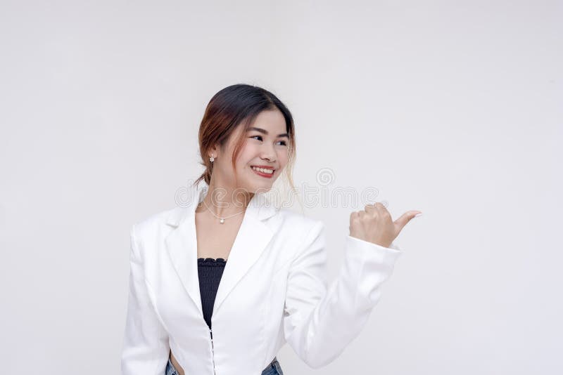 A Smiling Young Woman Looking Sideways while Gesturing To Her Right ...