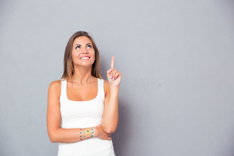 Smiling Young Woman Pointing Finger Up Stock Photo - Image of pensive ... Smiling Young Woman Pointing Finger Up Stock Photo - Image of pensive ...