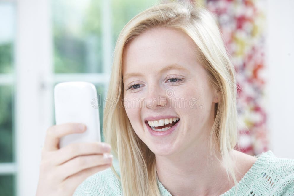 Smiling Young Woman Reading Text Message Stock Photo - Image of ...