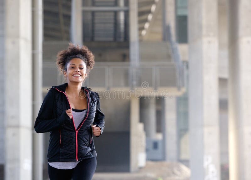 Smiling Young Woman Running Outside Stock Photo - Image of closeup ...