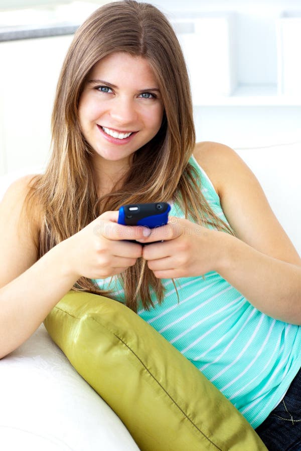 Smiling Young Woman Texting Sitting on the Sofa Stock Photo - Image of ... Smiling Young Woman Texting Sitting on the Sofa Stock Photo - Image of ...