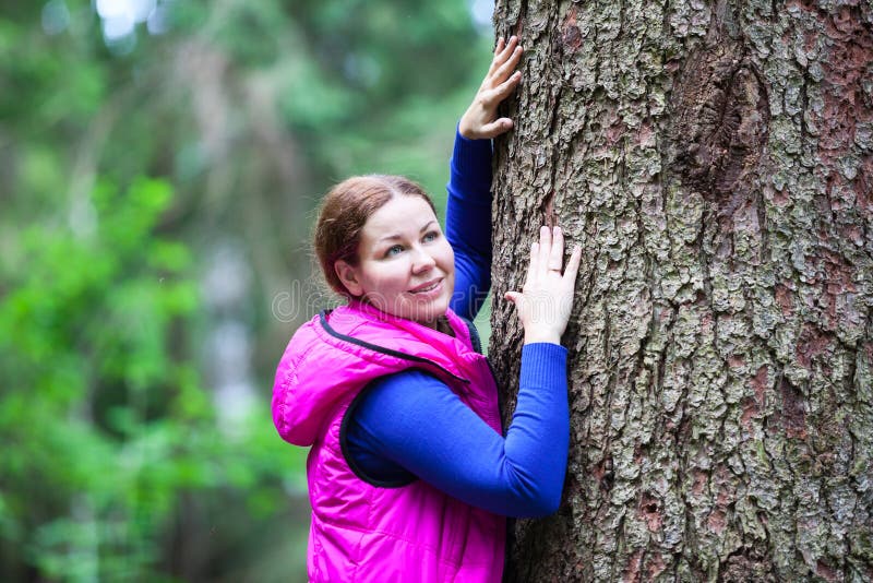 Smiling Young Woman Touching Stem of Big Pine Stock Photo - Image of ...