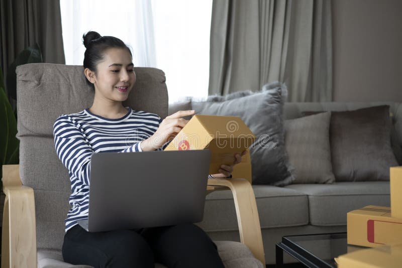 Smiling Woman Unpack Cardboard Parcel Box at Home. Stock Photo - Image ...