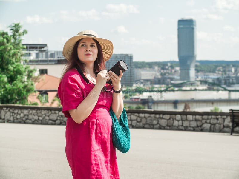 Smiling Woman Using a Camera To Take Photo Outdoors at the Park. Copy ...