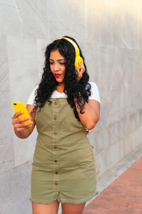 Smiling Young Woman Using Cell Phone while Standing Upright Stock Image ...