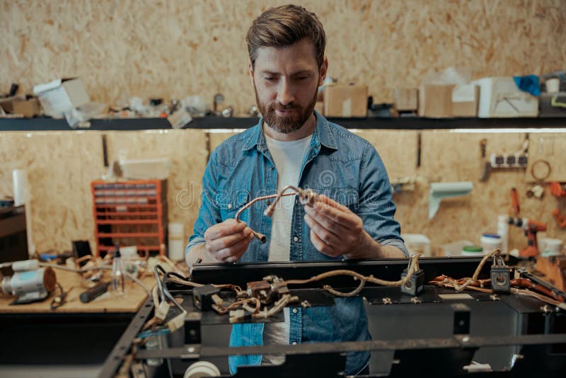 Smiling Young Worker Repairing Coffee Machine in a Workshop Stock Photo ...