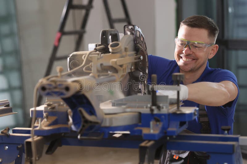 A Smiling Young Worker Serves a Metal Cutting Machine Stock Photo ...