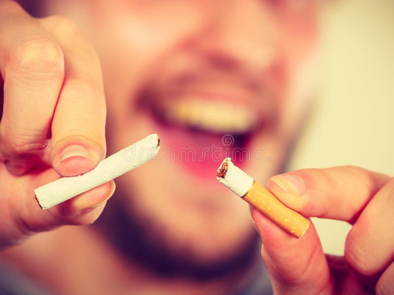 Smilling Man is Breaking a Cigarette Stock Image - Image of nonsmoking ...