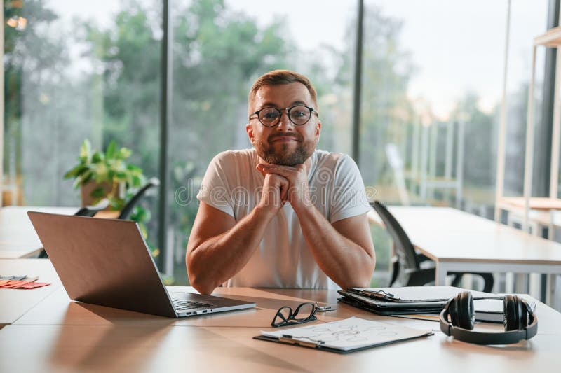 Smilling and Sitting. Positive Man in Formal Clothes is Working in the ...