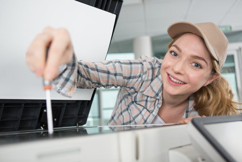 Smily Female Technician Looking at Printer Stock Photo - Image of ...