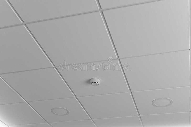 Smoke Fire Alarm Detector. Installed on the White Ceiling in the ...