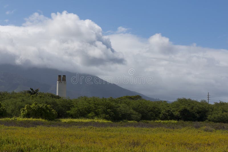Smoke Stack Beyond a Field stock image. Image of sunny - 43009799