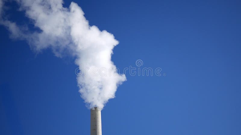 A Smoke Stack Blowing Smog or Water Vapor Our of Tower on Clear Sky ...