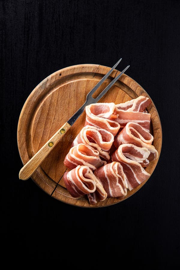 Smoked Bacon Strips and Fork on Cutting Board Stock Photo - Image of ...