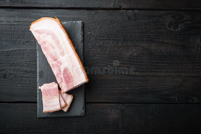 Smoked Bacon, Whole Slab on Black Wooden Table, Top View with Space for ...