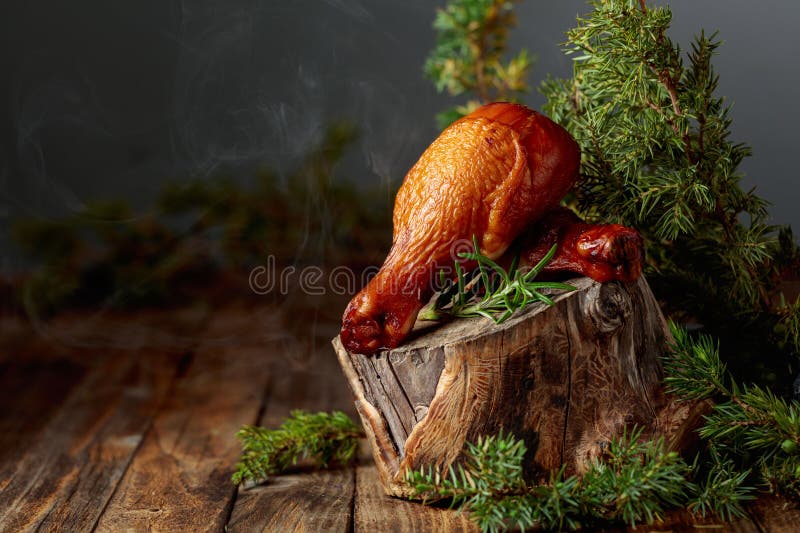 Smoked Chicken Drumsticks and Juniper Branches on a Wooden Table Stock ...