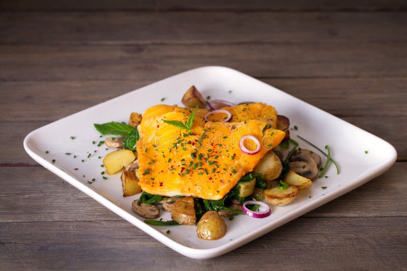 Smoked Cod Fish Fillets with Potatoes, Mushrooms and Spinach. Stock ...