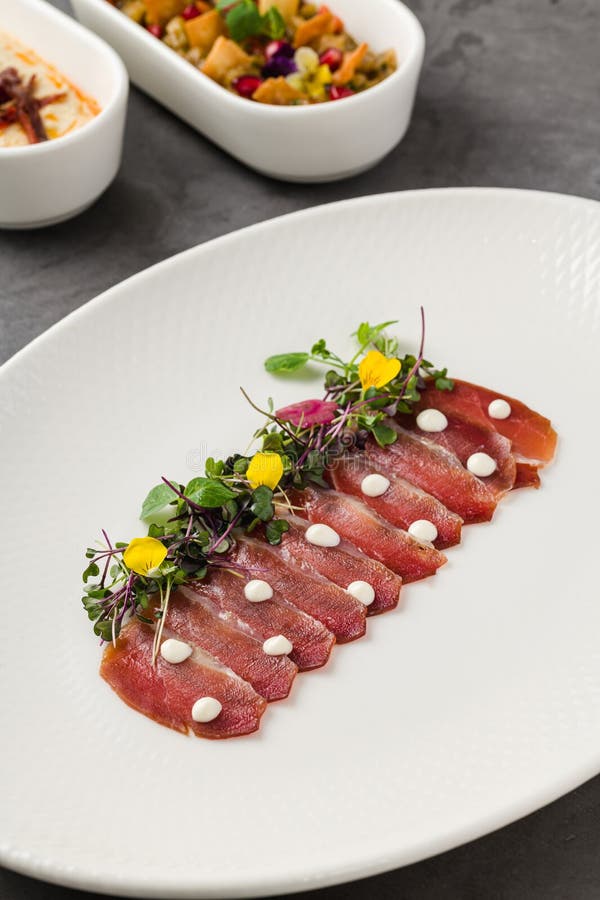 Smoked Duck Pastrami in White Porcelain Plate on Stone Table Stock ...