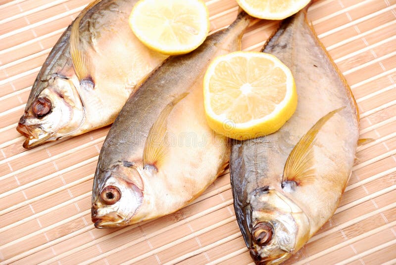 Smoked fish with a lemon stock photo. Image of snack - 10842234