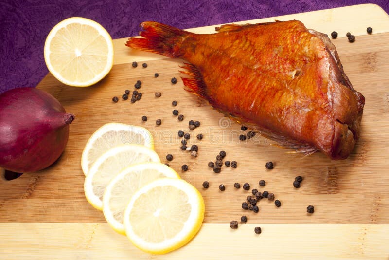 Smoked fish and lemon stock image. Image of cooking, board - 21927785