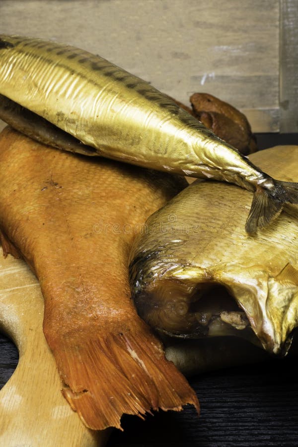 Smoked Fish, Mackerel, Sig, Perch and Cod Roe on the Black Wooden Table ...