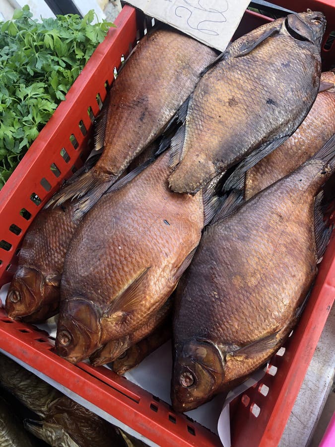 Smoked fish on the market stock image. Image of leaf - 234285673